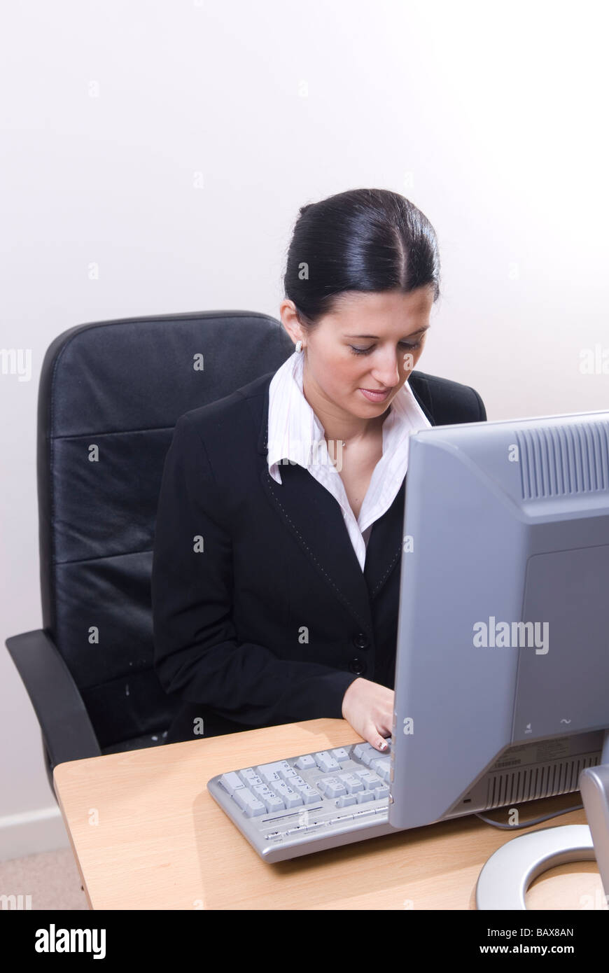 Business woman typing on a keyboard at work Stock Photo - Alamy