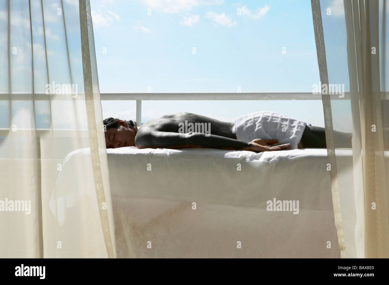 Man sunbathing balcony hi-res stock photography and images - Alamy