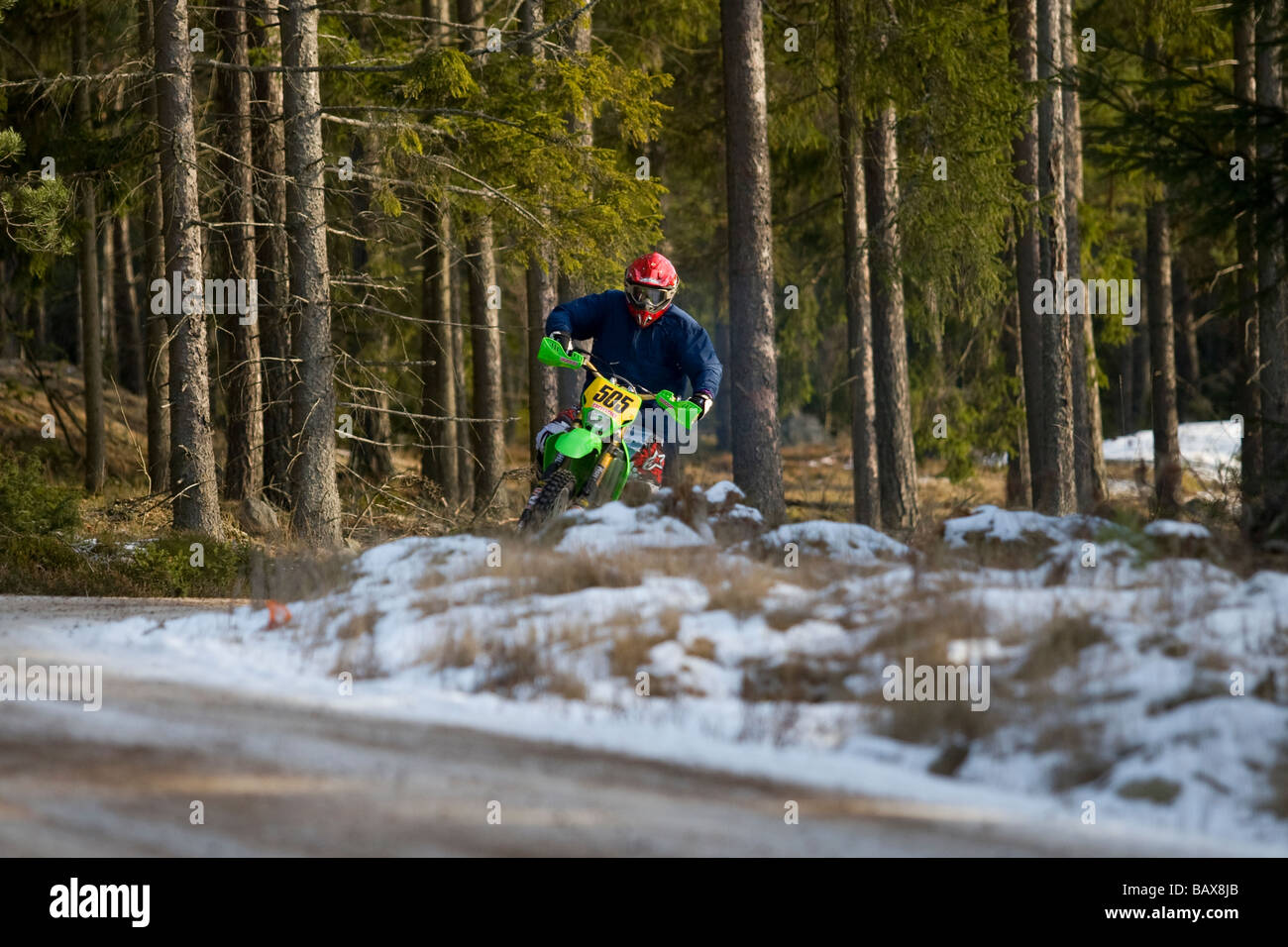 Enduro mc on a gravelraod in the wood Stock Photo - Alamy