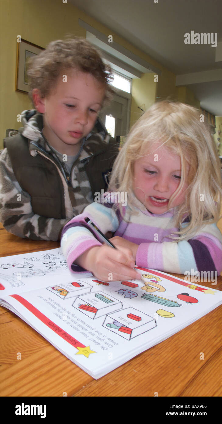Children drawing and colouring and doing homework at home Stock Photo ...