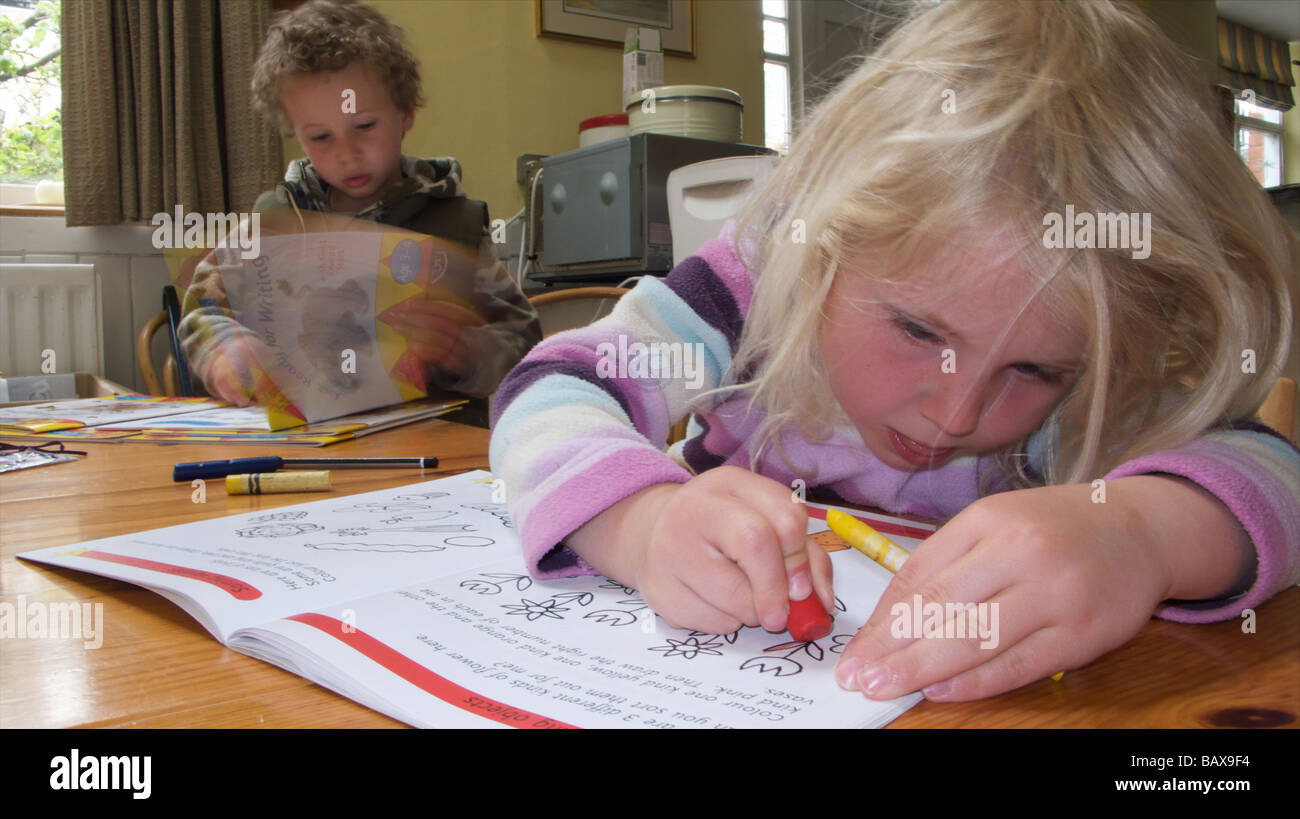 Children drawing and colouring and doing homework at home Stock Photo ...