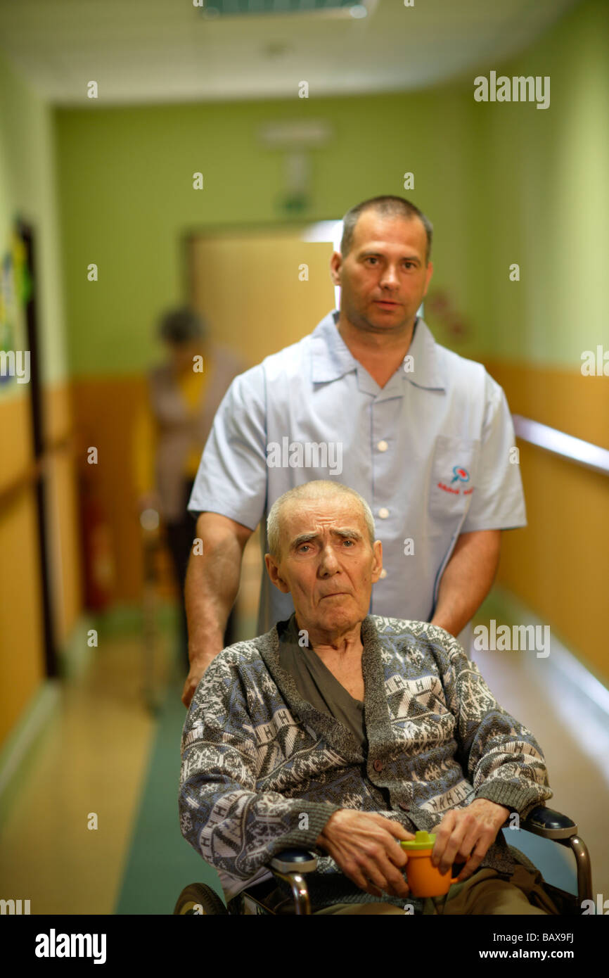 Nursing home elderly man with a man nurse Stock Photo - Alamy