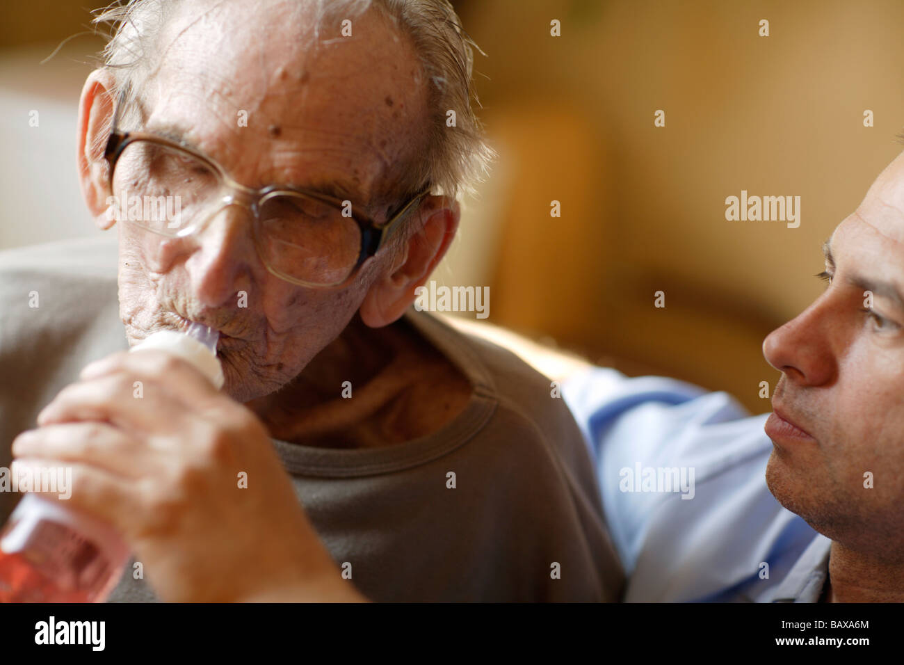 Nursing home elderly man with a man nurse Stock Photo - Alamy