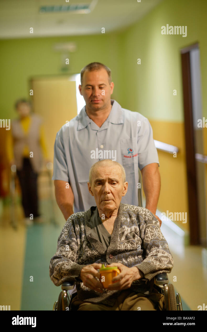 Nursing home elderly man with a man nurse Stock Photo - Alamy