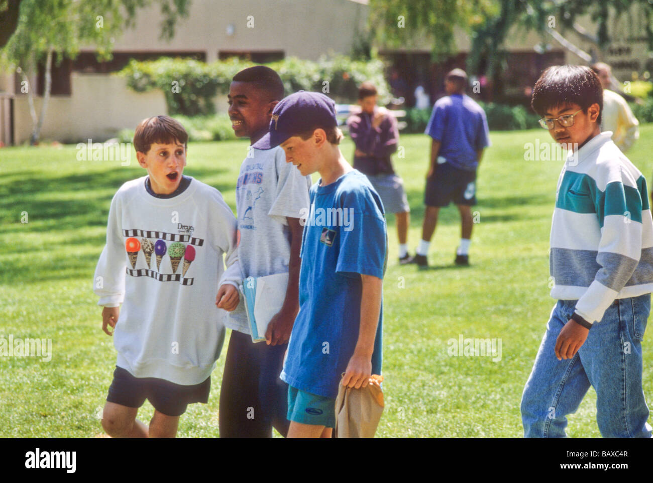 Teen boys talk school campus outdoor outside sun grass visit share ...