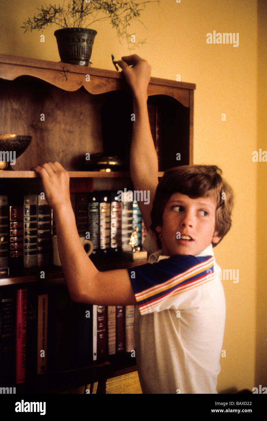 Teen boy sneak find hide key suspicious scared afraid leery steal Stock ...