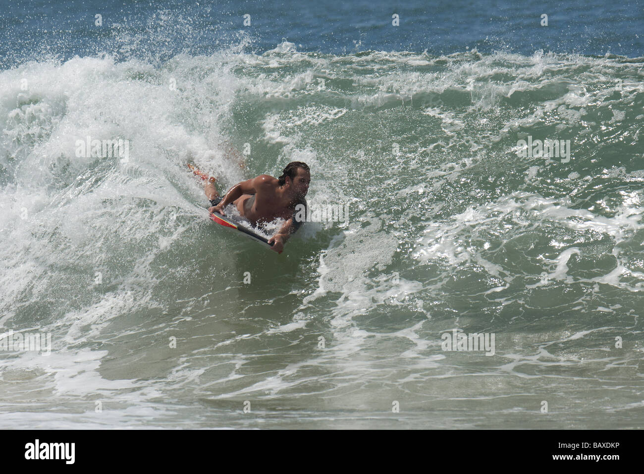 Bodyboarding at Estaleiro Beach Stock Photo - Alamy