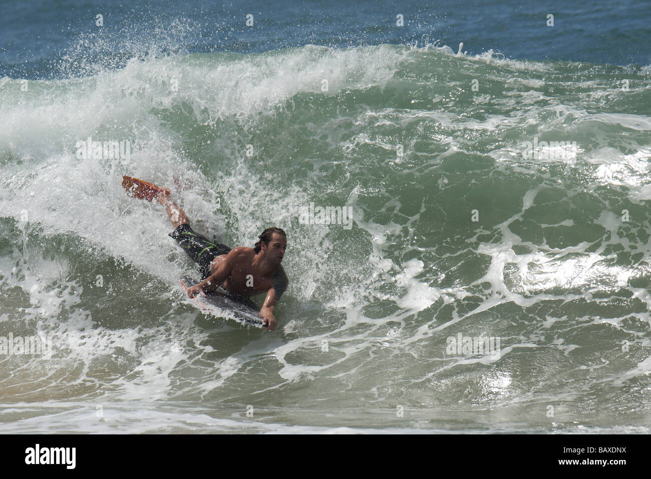 Bodyboarding at Estaleiro Beach Stock Photo - Alamy