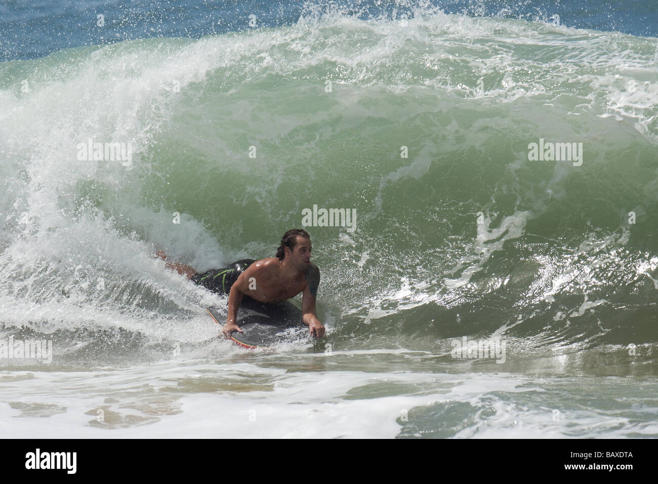 Bodyboarding at Estaleiro Beach Stock Photo - Alamy