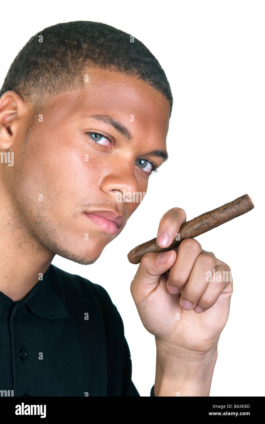 A young African American man poses with a cigar before smoking it Stock ...