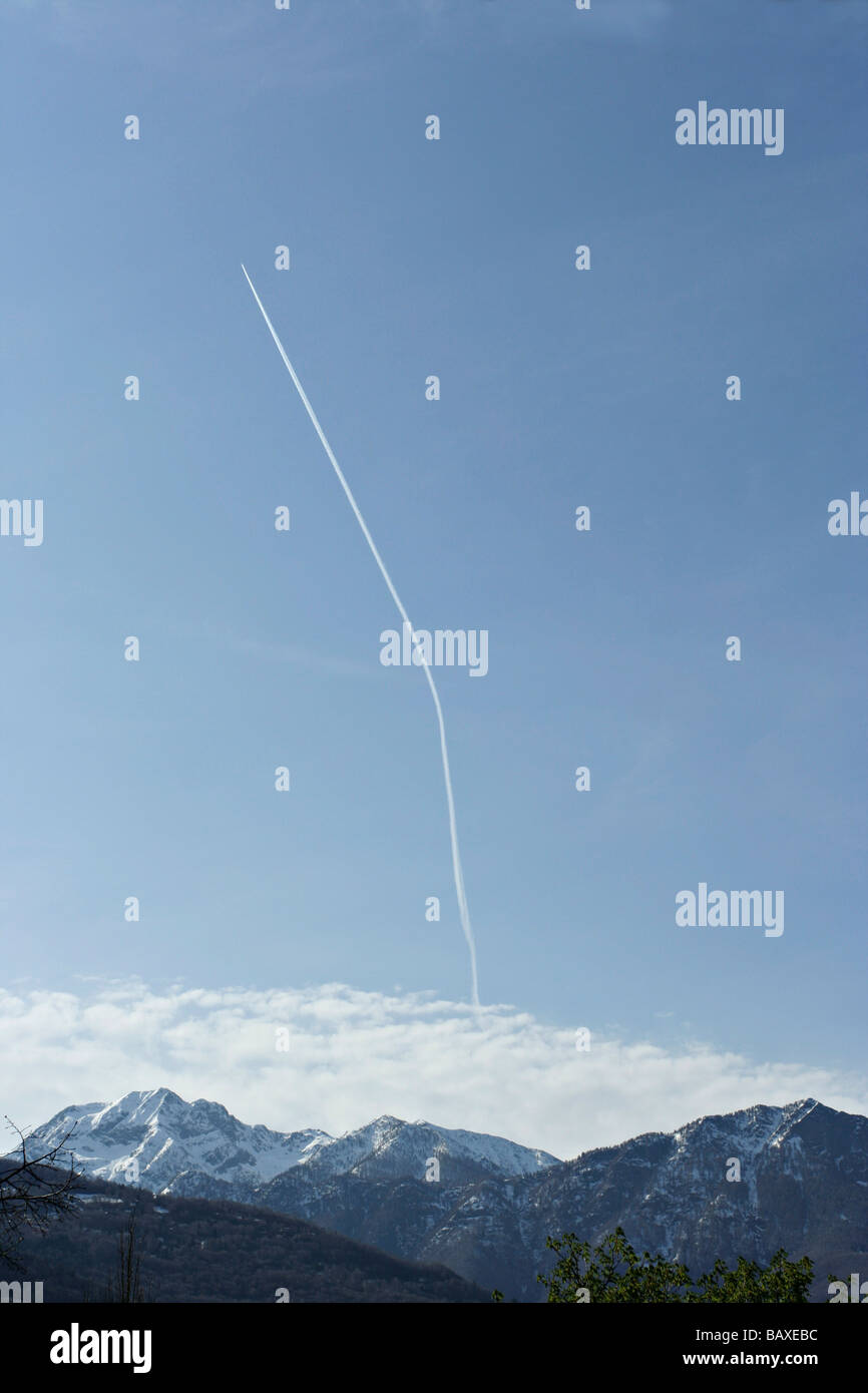 A jetplane flying over mountain top Stock Photo - Alamy