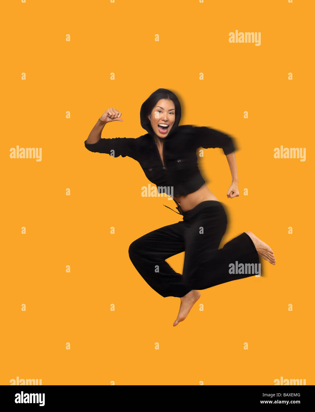 Blurred motion shot of Asian woman jumping Stock Photo - Alamy