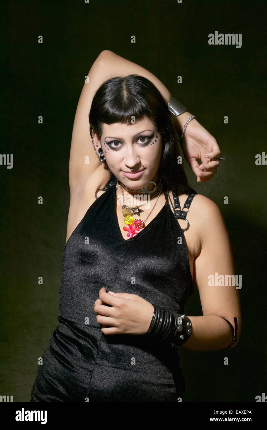 Hispanic Goth woman with arm behind head Stock Photo - Alamy