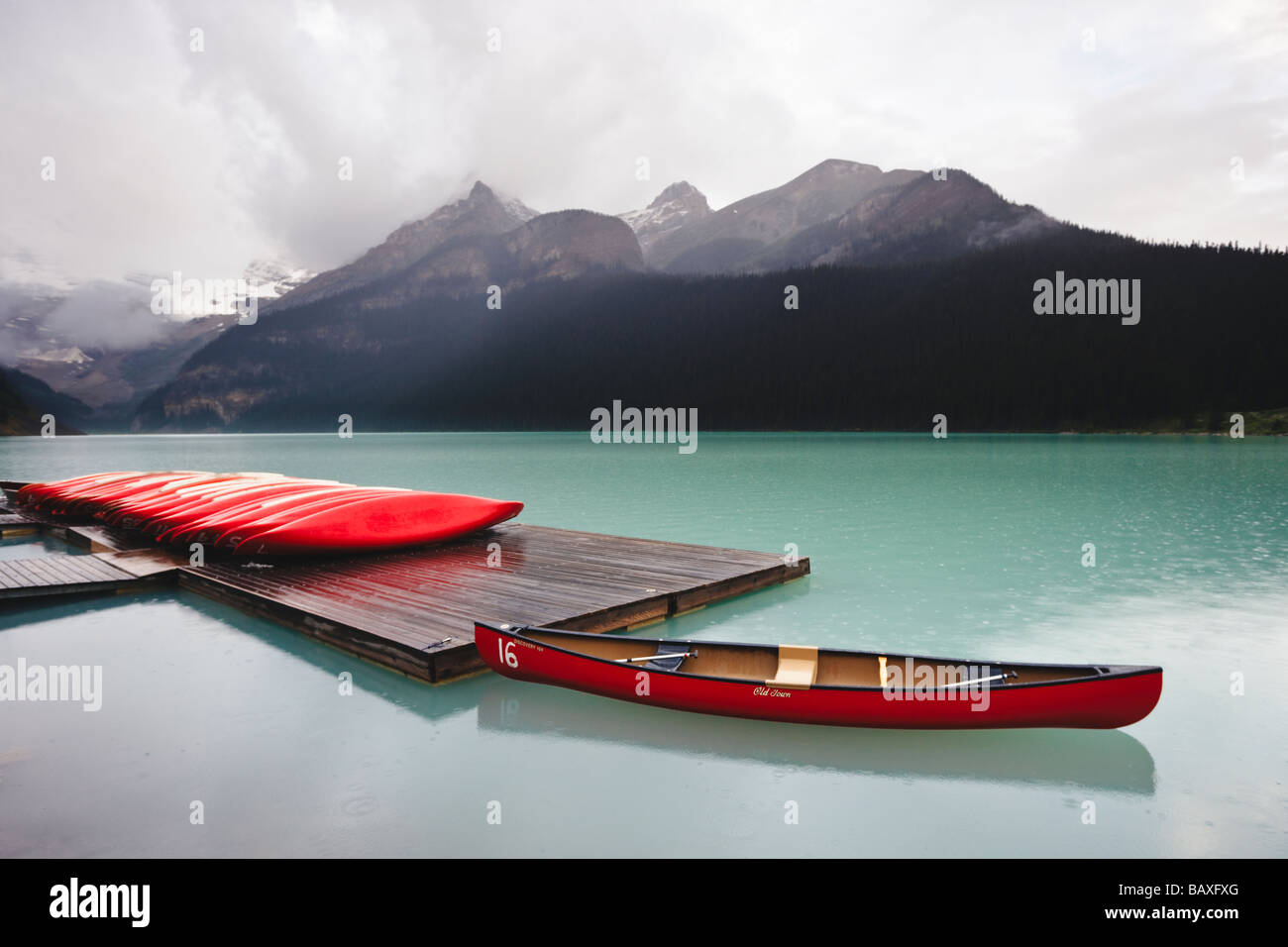 Canoes in the rain on Lake Louise, Banff National Park Stock Photo - Alamy