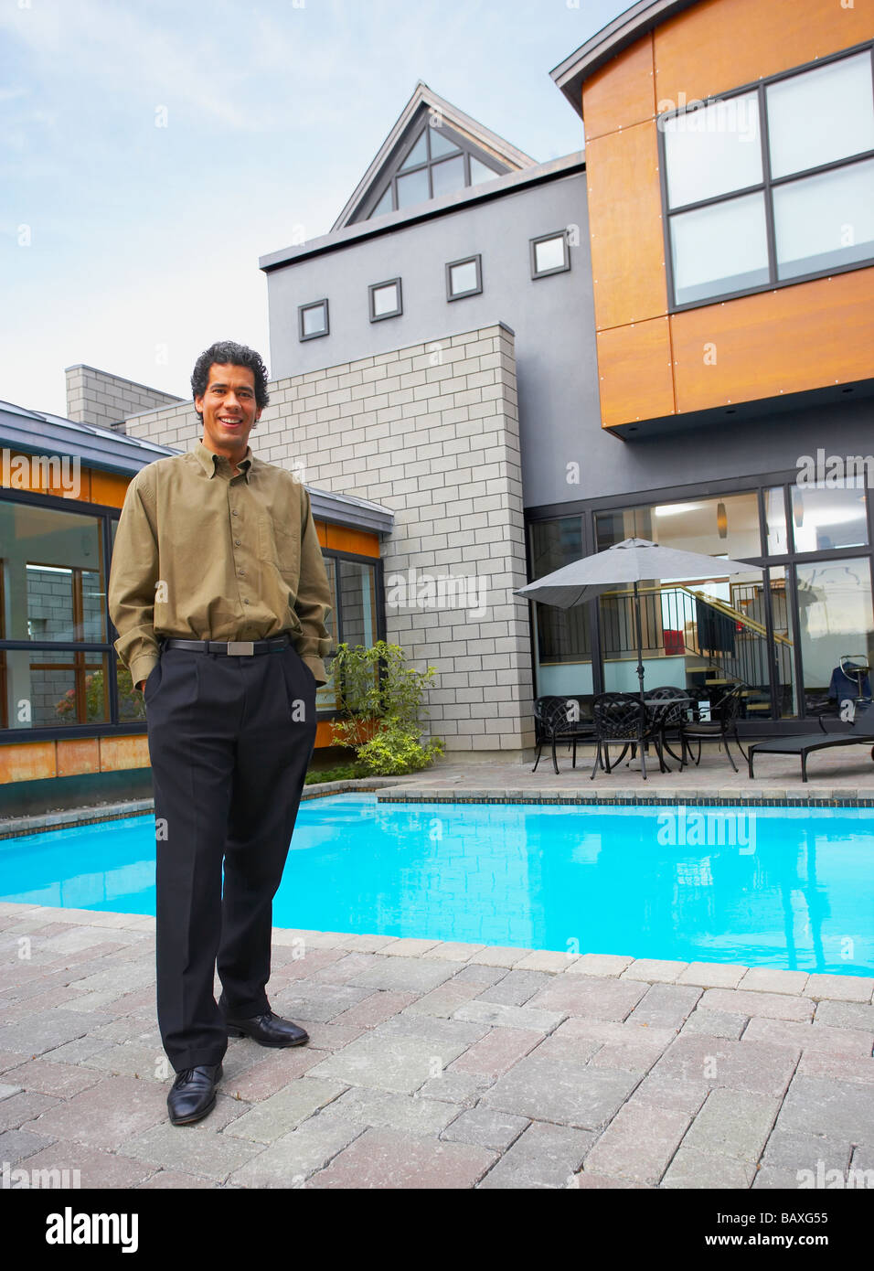 Man standing on patio of house Stock Photo - Alamy
