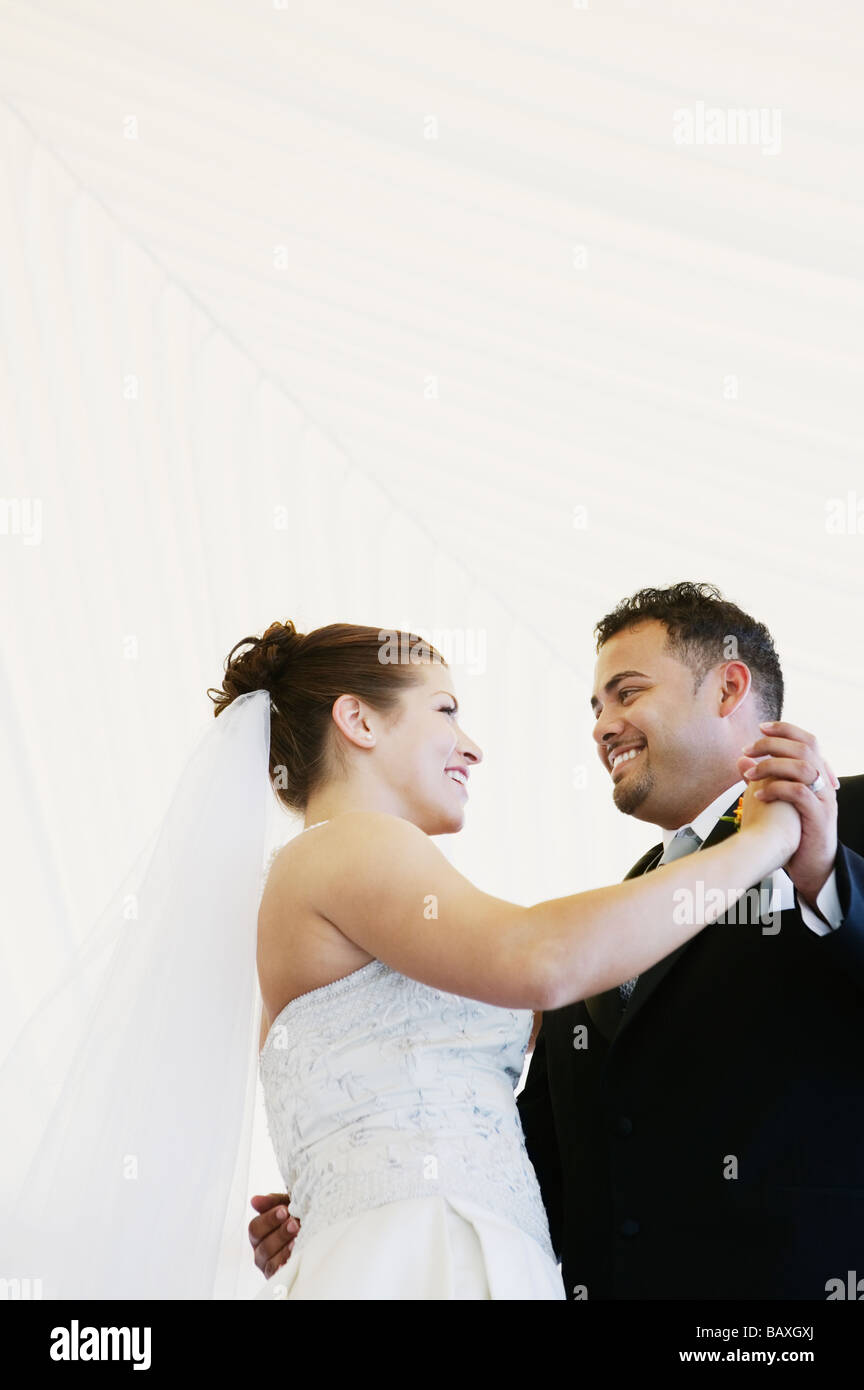 Multi-ethnic bride and groom dancing Stock Photo - Alamy