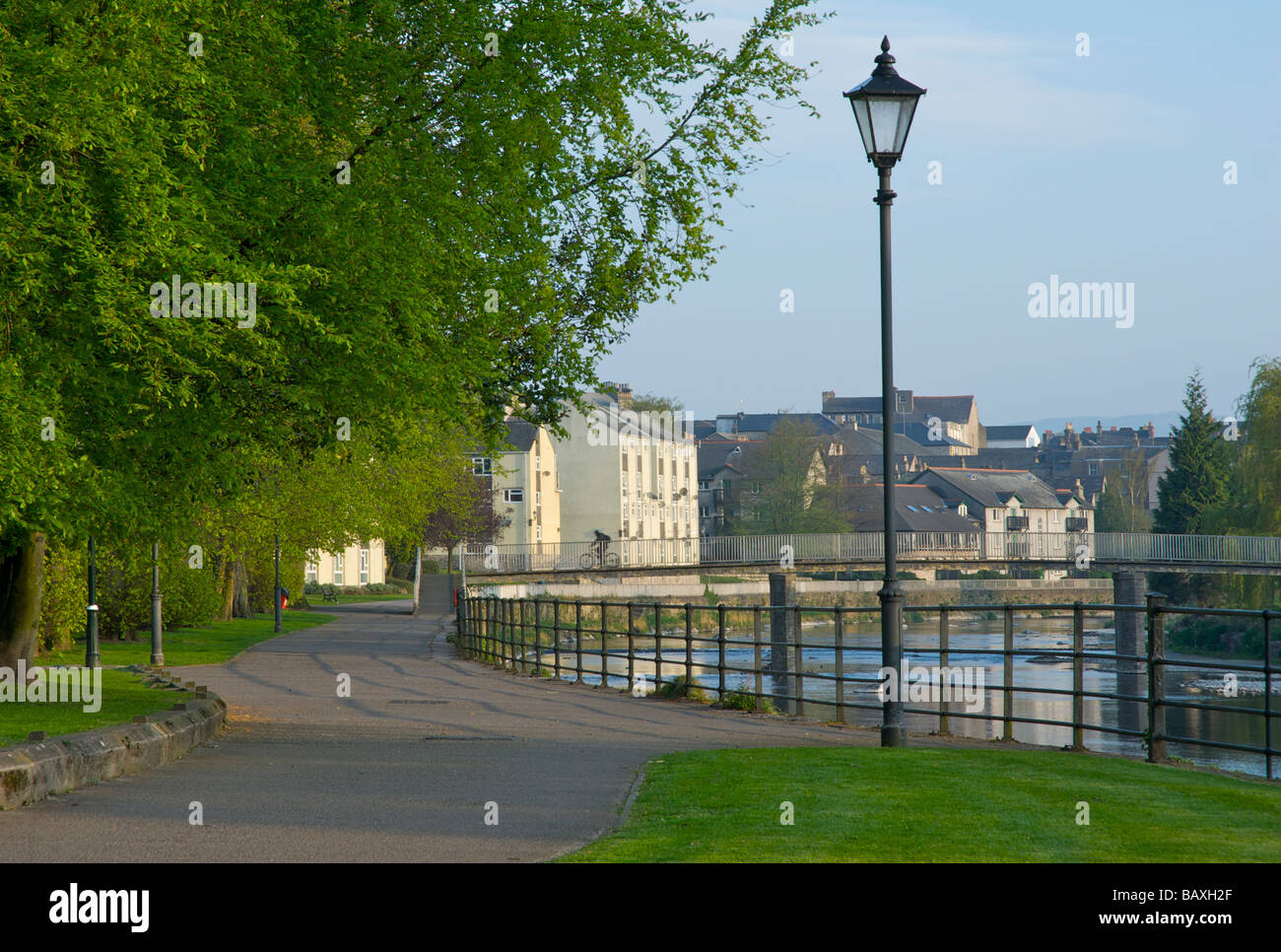 Cyclist on footbridge over the River Kent, Kendal, Cumbria, England UK ...
