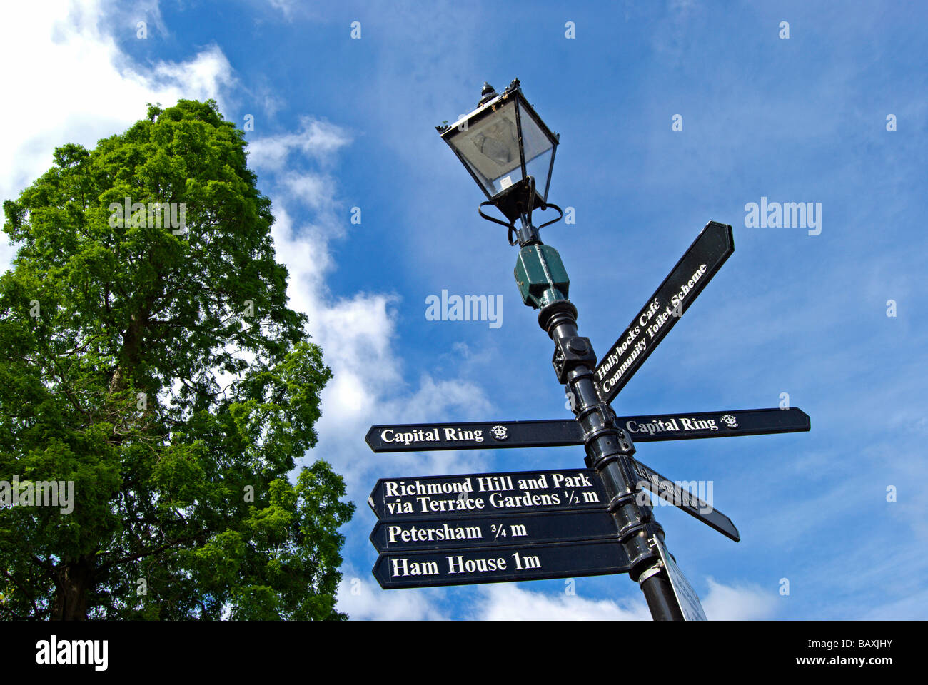 victorian style street light and signpost with direction markers for ...