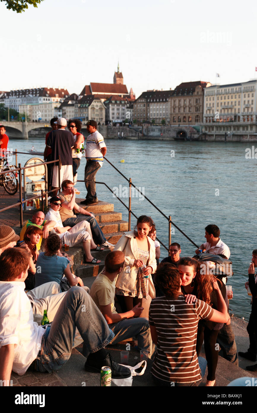Young people on the river bank, Riviera Klein-Basel, Basel, Switzerland ...