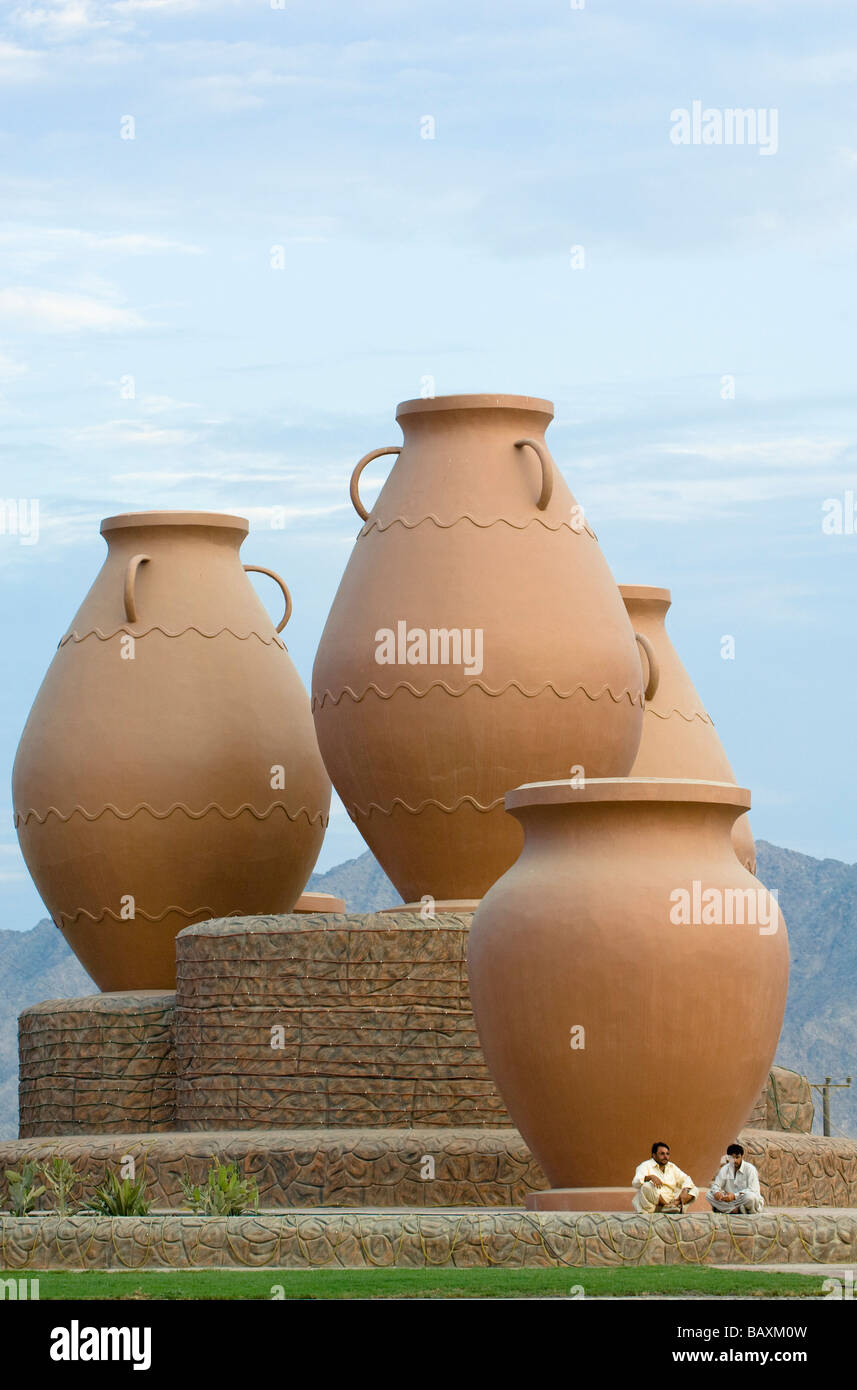 Two men sitting in front of giant clay jugs, Roundabout, Dibba, Oman ...