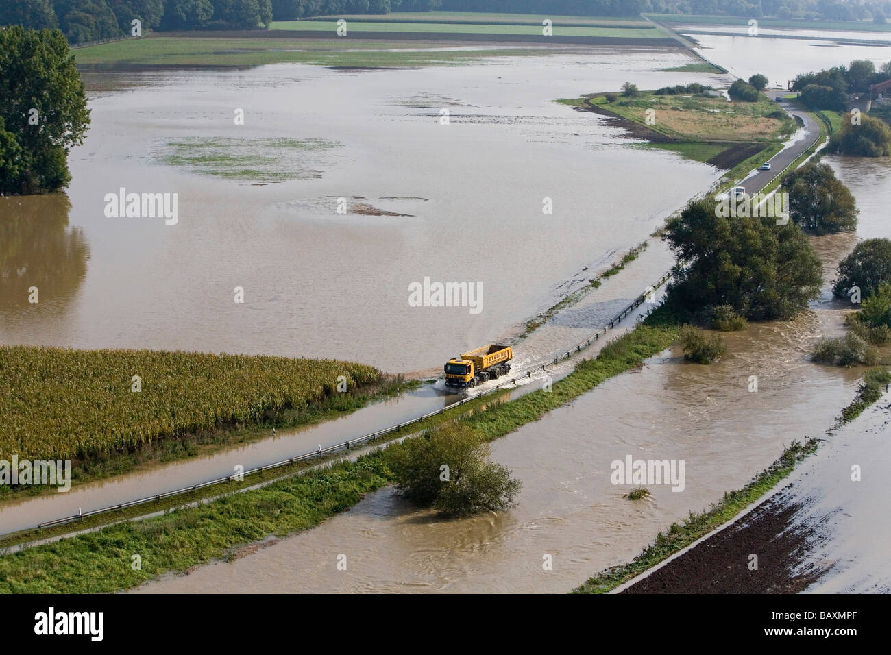 aerial view of truck driving through floodwaters, farmland, Leine River ...