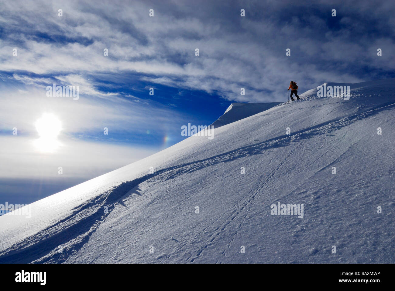 backcountry skiier on ridge with cornices and ski tracks, Kuehgundkopf ...