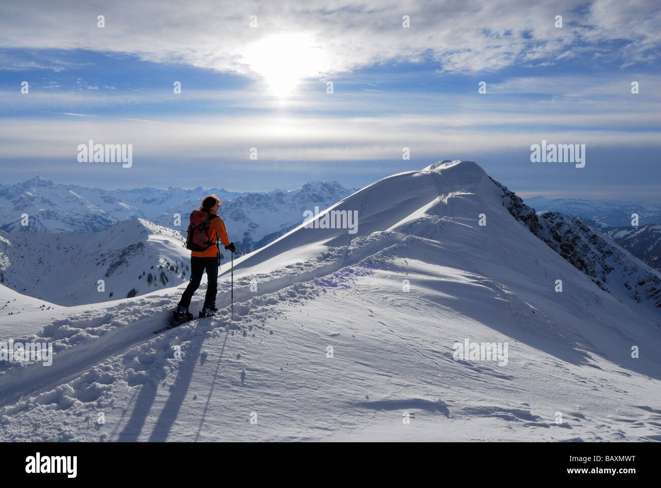 backcountry skiier on ridge with cornices and ski tracks, Kuehgundkopf ...