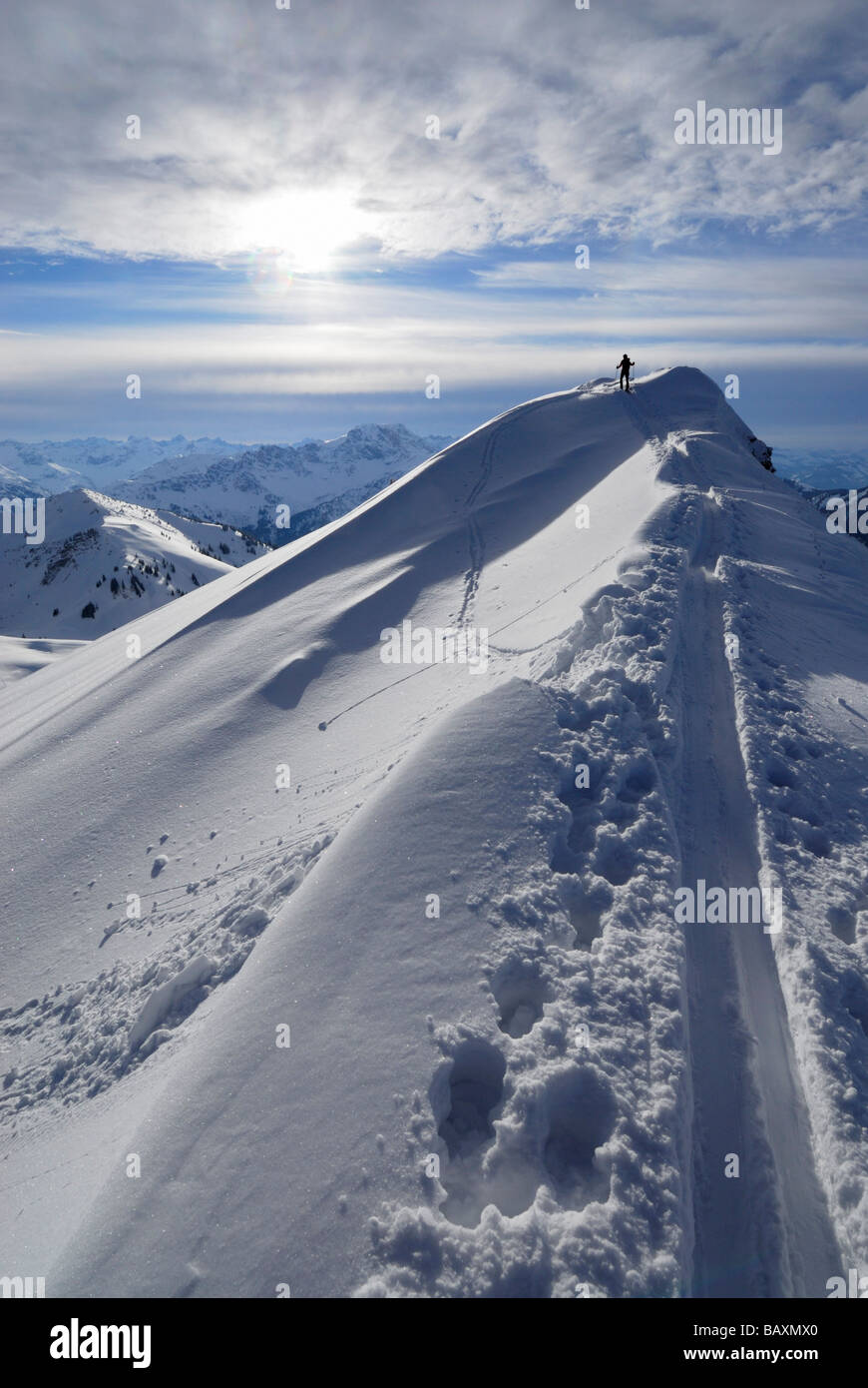 backcountry skiier on ridge with cornices and ski tracks, Kuehgundkopf ...