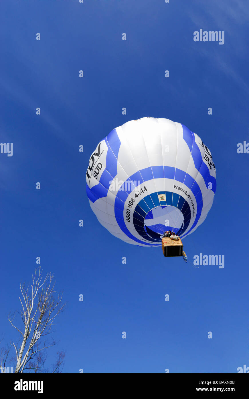 ballooning, hot air balloon with waving passengers in gondola ...