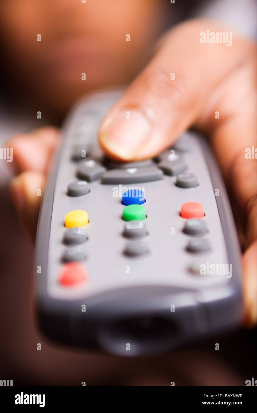Woman with TV remote Stock Photo - Alamy