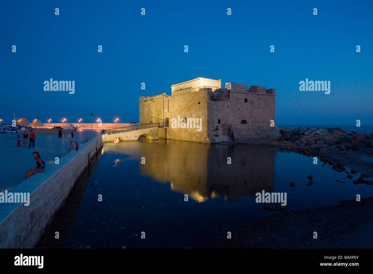 Paphos Castle at Paphos harbour at night, reflection in the water ...