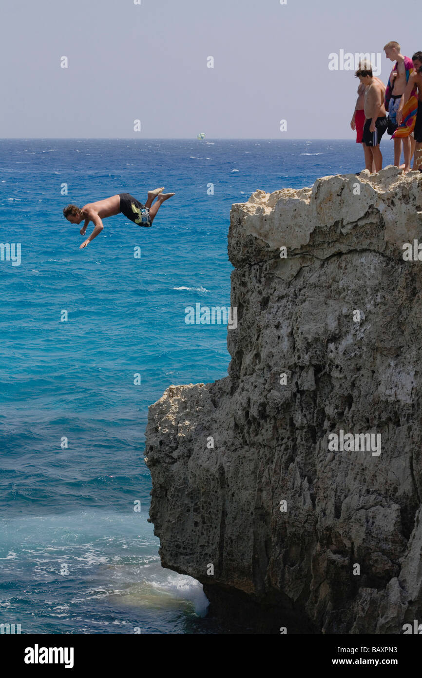 Man cliff jumping, diving from a the rock, Nissi island, Nissi beach ...