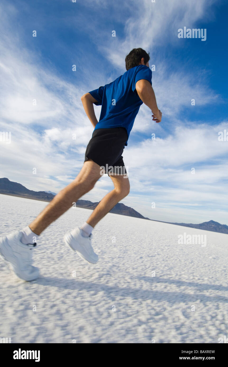 Hispanic man jogging on salt flats Stock Photo - Alamy