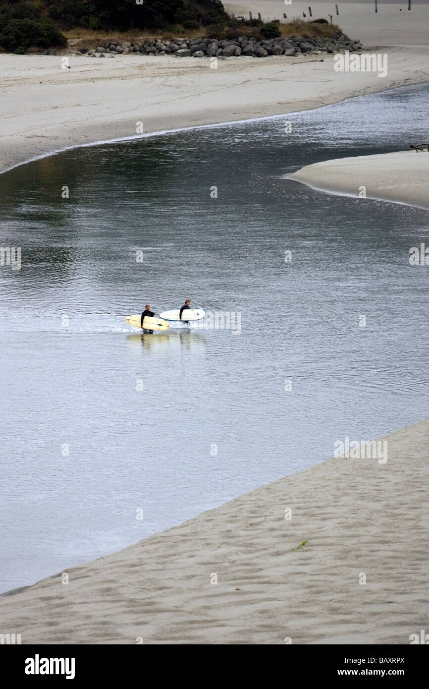 Surfers crossing tidal river - Mendocino, California Stock Photo - Alamy