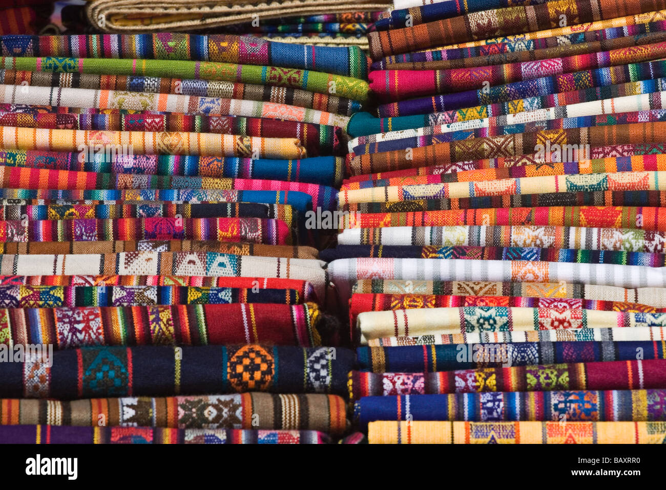 Brightly coloured locally woven fabrics at the famous market in Otavalo ...