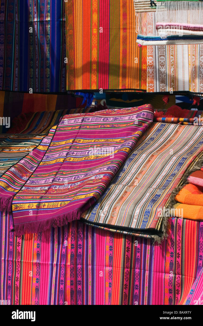 Brightly coloured locally woven fabrics at the famous market in Otavalo ...