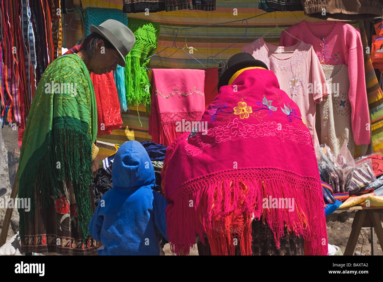 Indigenous women in brighly coloured shawls at the market in Saquisili ...