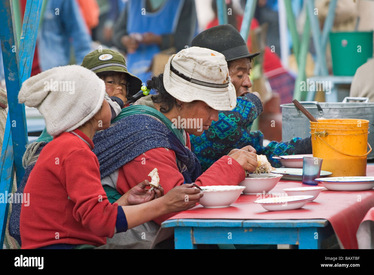 Indigenous family eating at a food stall at the huge market in ...