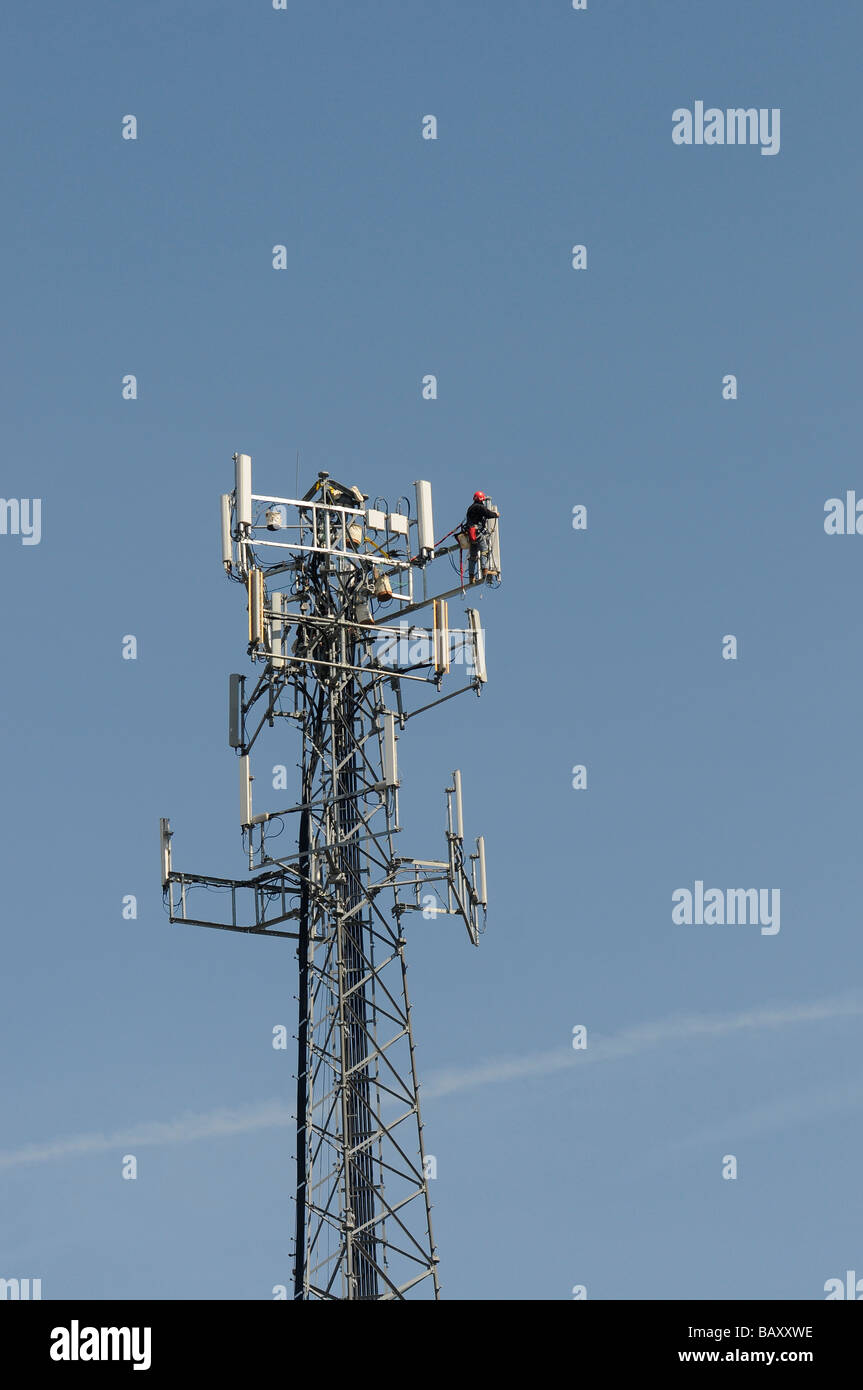 Men in safety harnesses working on cell tower Stock Photo - Alamy