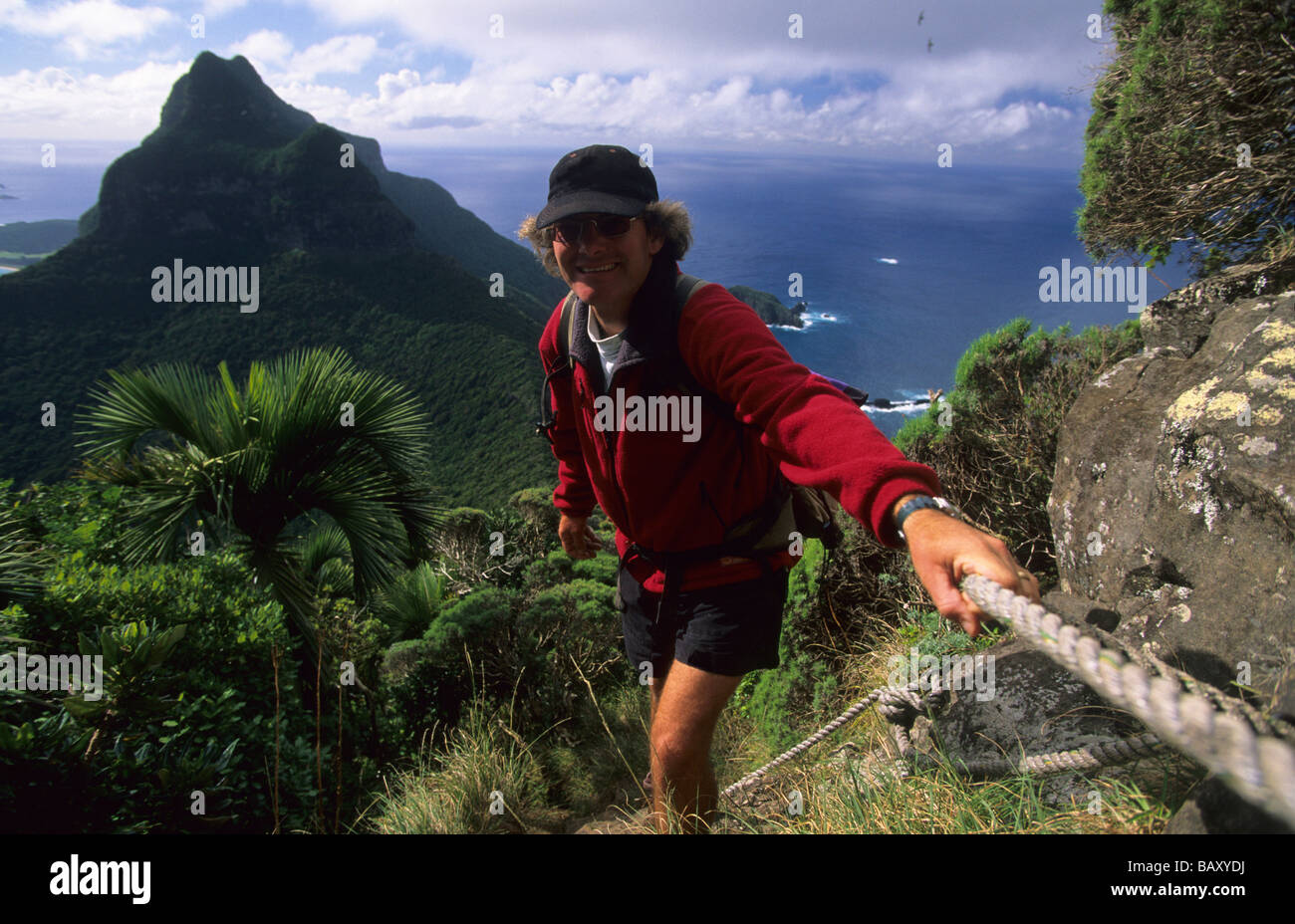 Man climbing onto Mt. Gower, Lord Howe Island, Australia Stock Photo ...