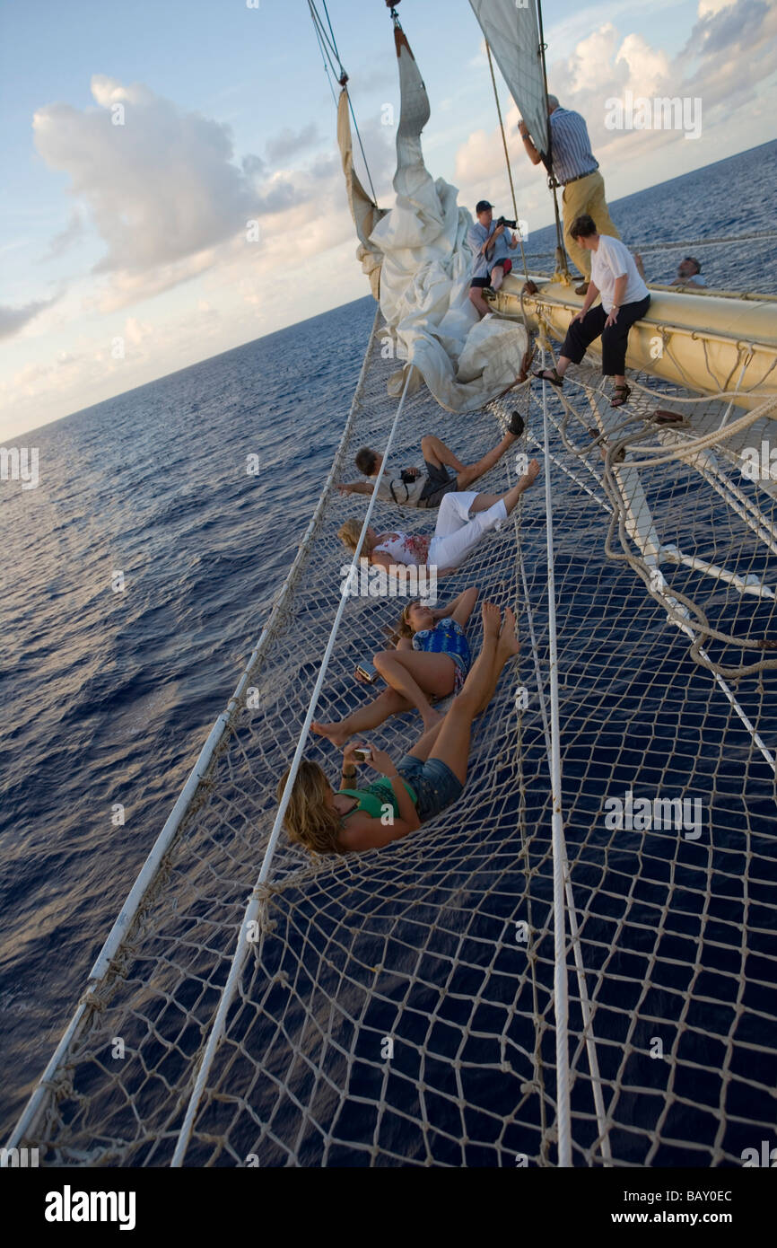 Passengers relaxing in bowsprit net of sailing Cruiseship Star Flyer ...