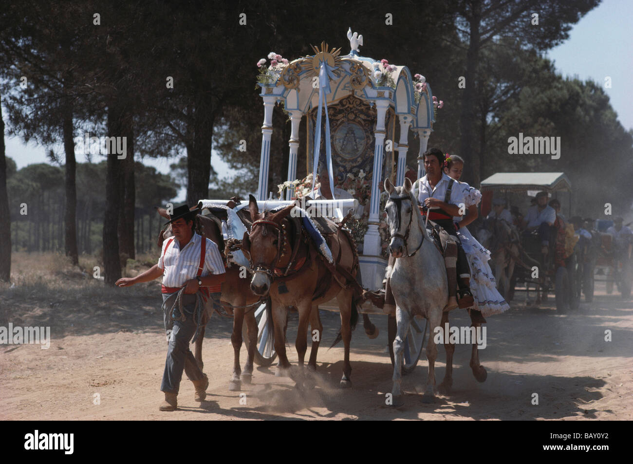Procession of pilgrims on horseback and on foot, a mule driven cart ...