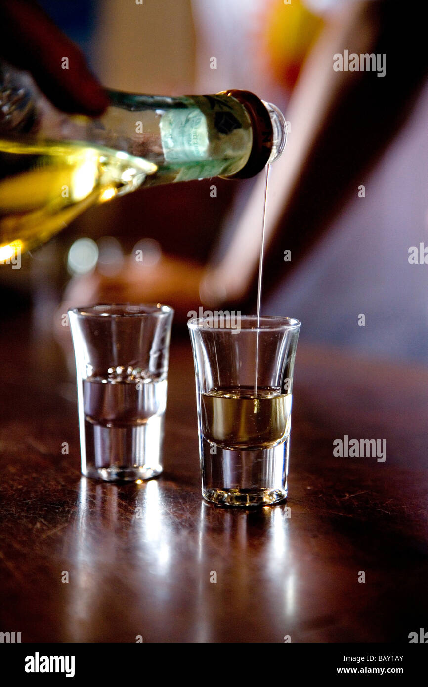 Person pouring Grappa into two glasses, Nardini Grappa Bar, Bassano del ...