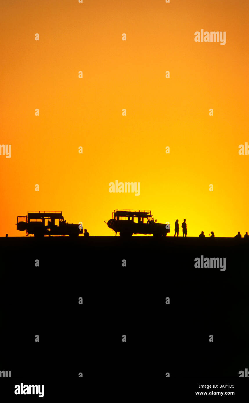 Group of tourists with cars on dune at dusk, Walvis Bay, Namibia ...