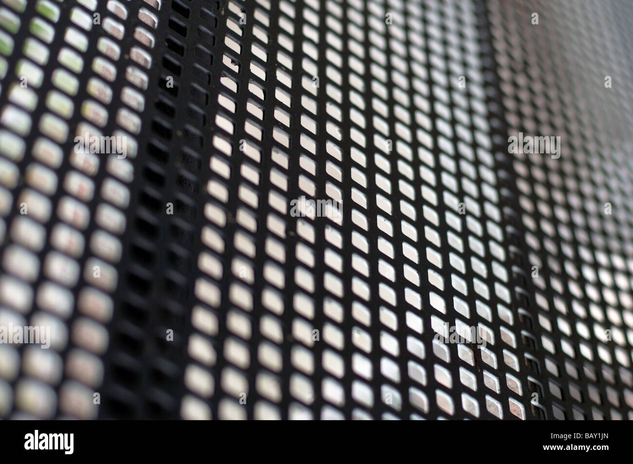 Hole pattern in a metal bar, detail Stock Photo - Alamy