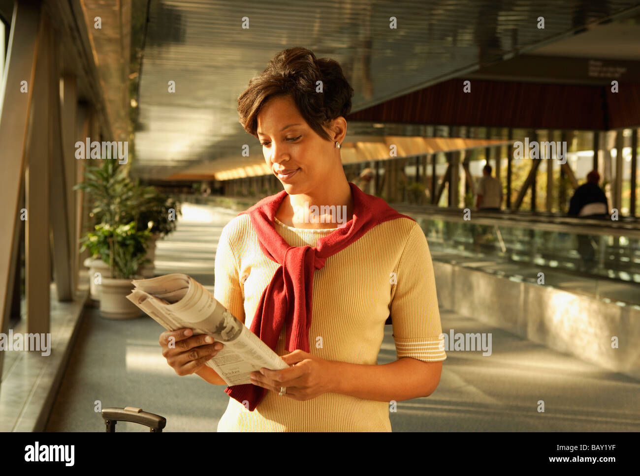 African woman reading newspaper Stock Photo - Alamy