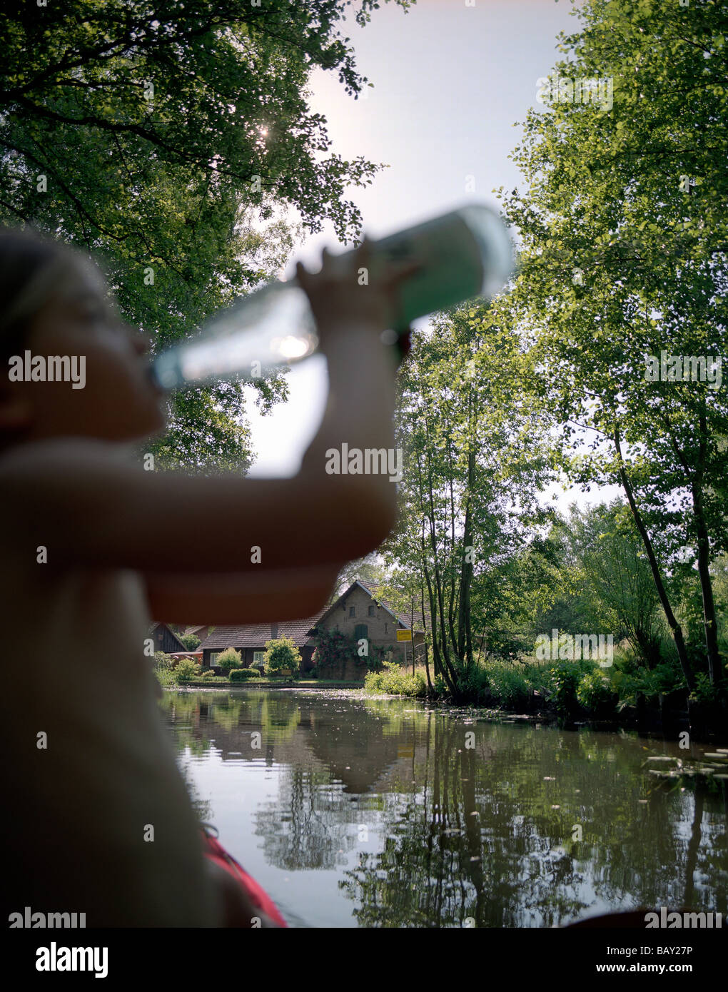 Girl drinking water during a canoe tour, farm house in Lehde, Lehder ...