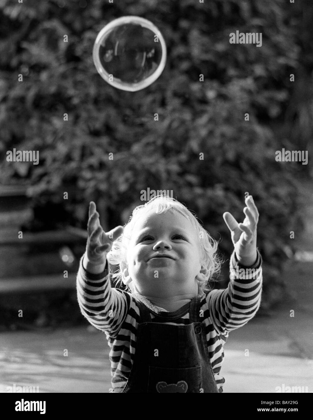 Four years old boy catching a bubble Stock Photo - Alamy