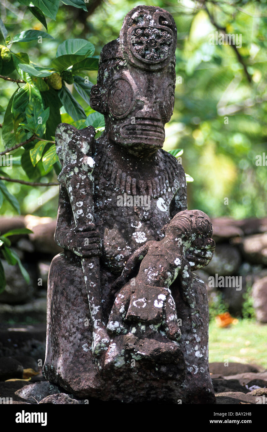 Weather beaten statue made of stone, Tiki in the village of Hatiheu on ...