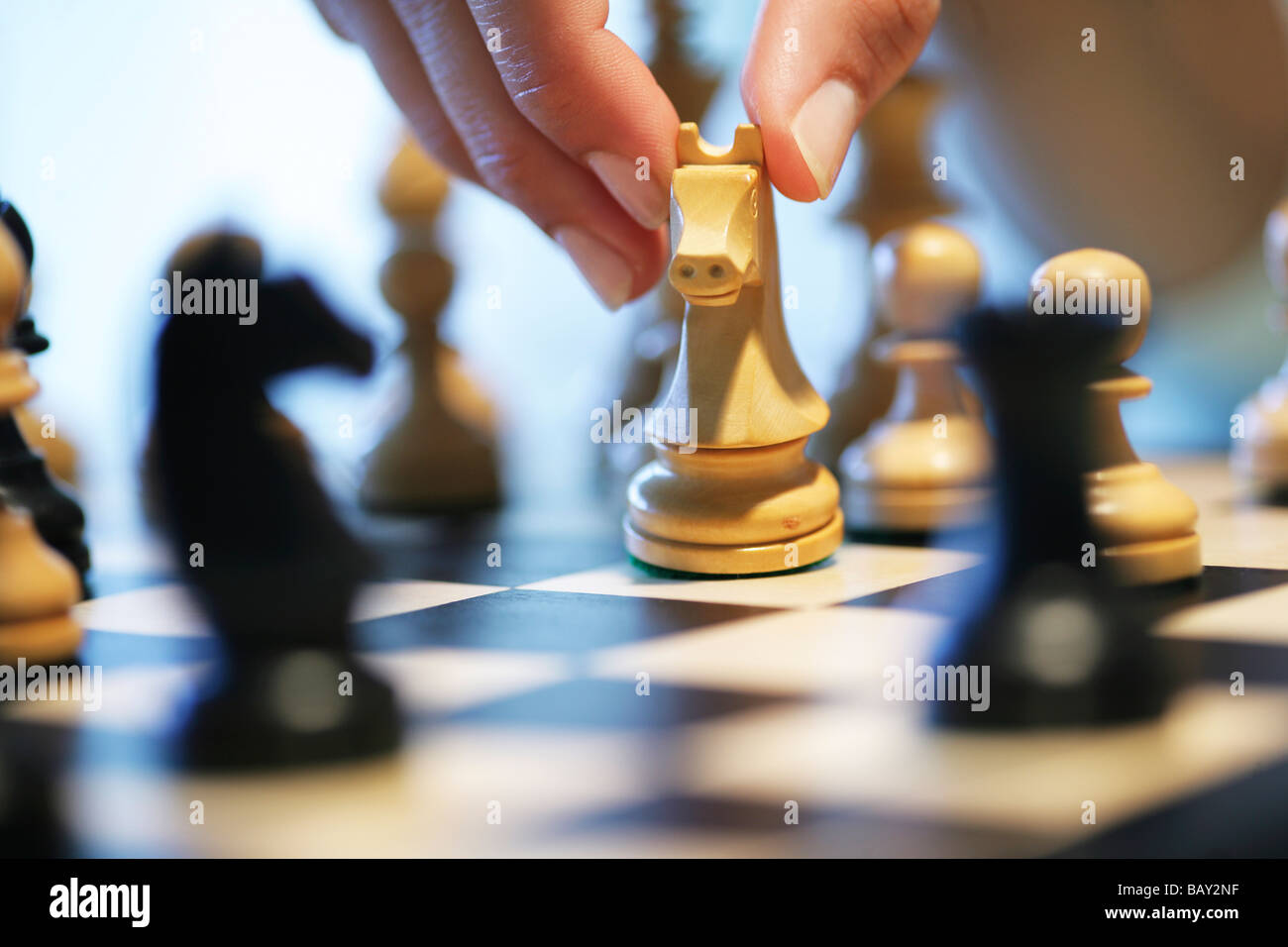 Hand with chess figure, chess game Stock Photo - Alamy